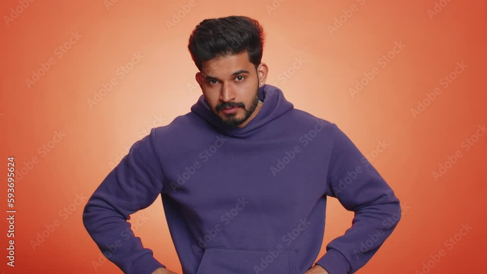 I am watching you. Young confident indian man pointing at his eyes and ...