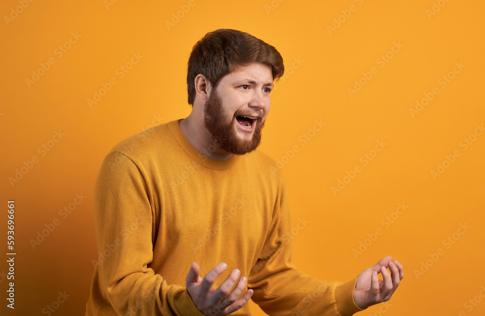 Portrait of emotive annoyed irritated unshaven male clenches teeth and ...