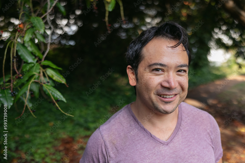 Smiling man outside in nature park. Stock Photo | Adobe Stock
