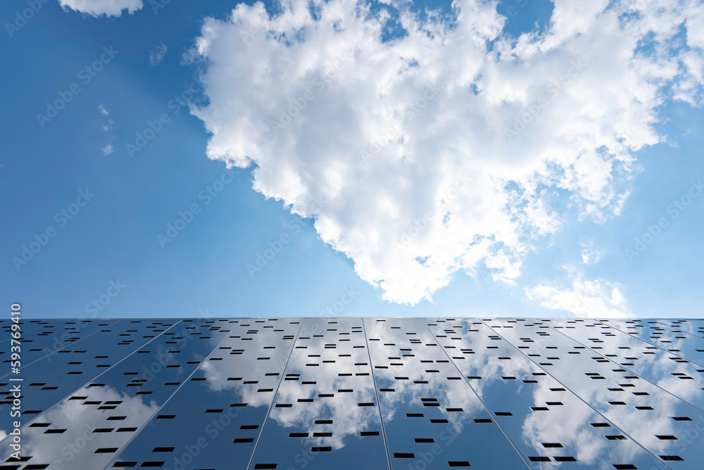 Modern building with the sky and clouds reflecting on its facade Stock ...