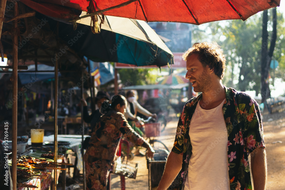 Tourist man looking at the stalls of a Southeast Asian market Stock ...