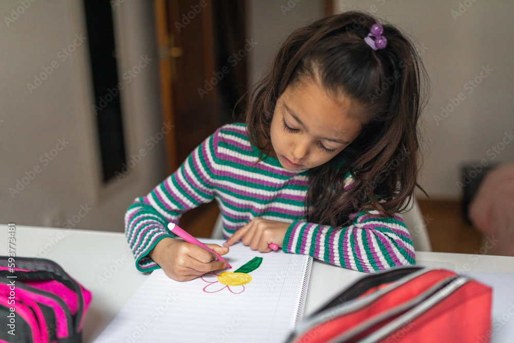 Concentrated little artist drawing at her desk in the room Stock Photo ...