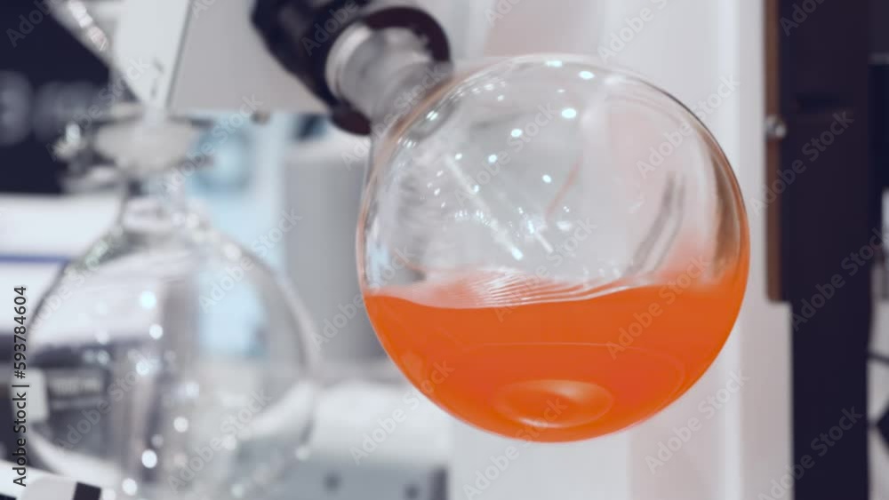 Liquid mixing in glass beaker for science experiment. Close up ...