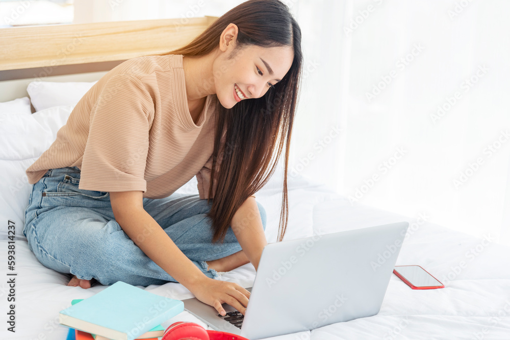 Happiness Asian Woman working from home using laptop online meeting in ...