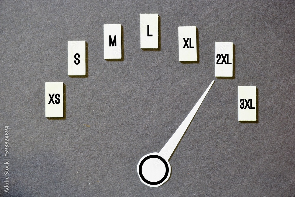 Body size chart meter for clothing with wooden chips on grey background ...