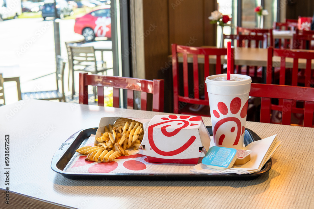 Chick-fil-a food on the table near the window in fast food restaurant ...