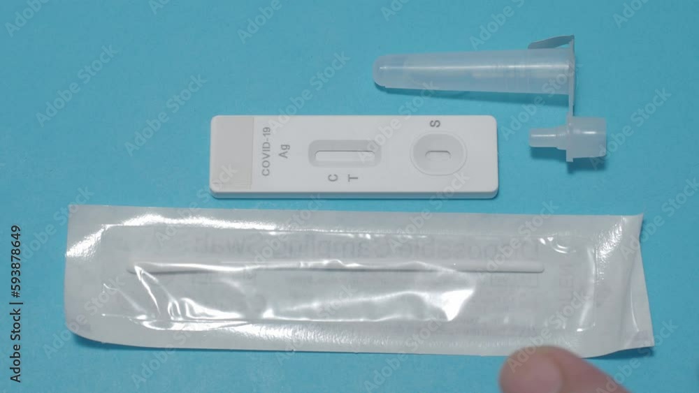 POV of Man hands using Rapid antigen test kit or ATK and blue ...