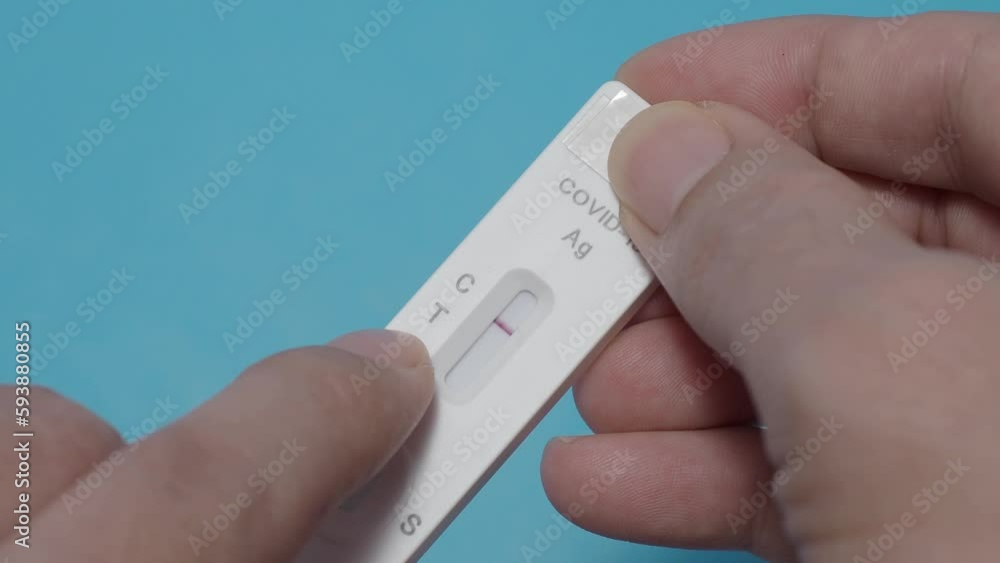 POV of Man hands using Rapid antigen test kit or ATK and blue ...