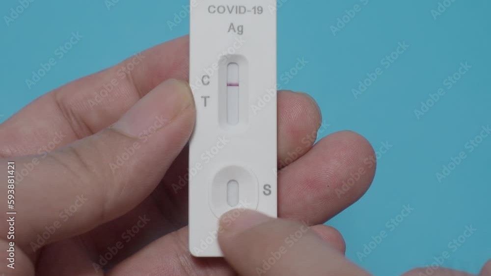 POV of Man hands using Rapid antigen test kit or ATK and blue ...