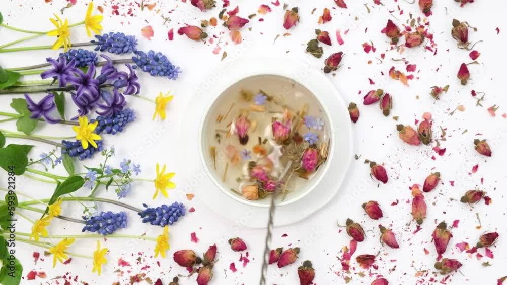 Healthy herbal tea in a white cup with medicinal herbs, flowers and ...