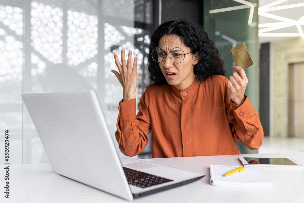 Dissatisfied and angry businesswoman inside the office, hispanic woman ...