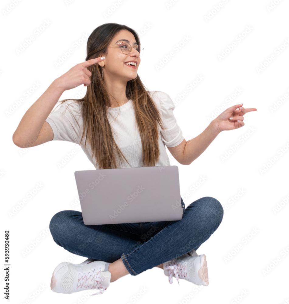 Demonstrating copy space, young woman sitting on the ground with laptop ...