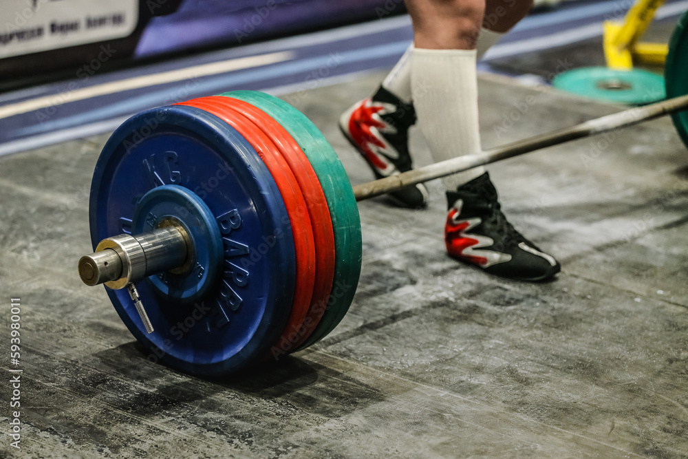 legs male athlete powerlifter and barbell lying on platform, starting ...