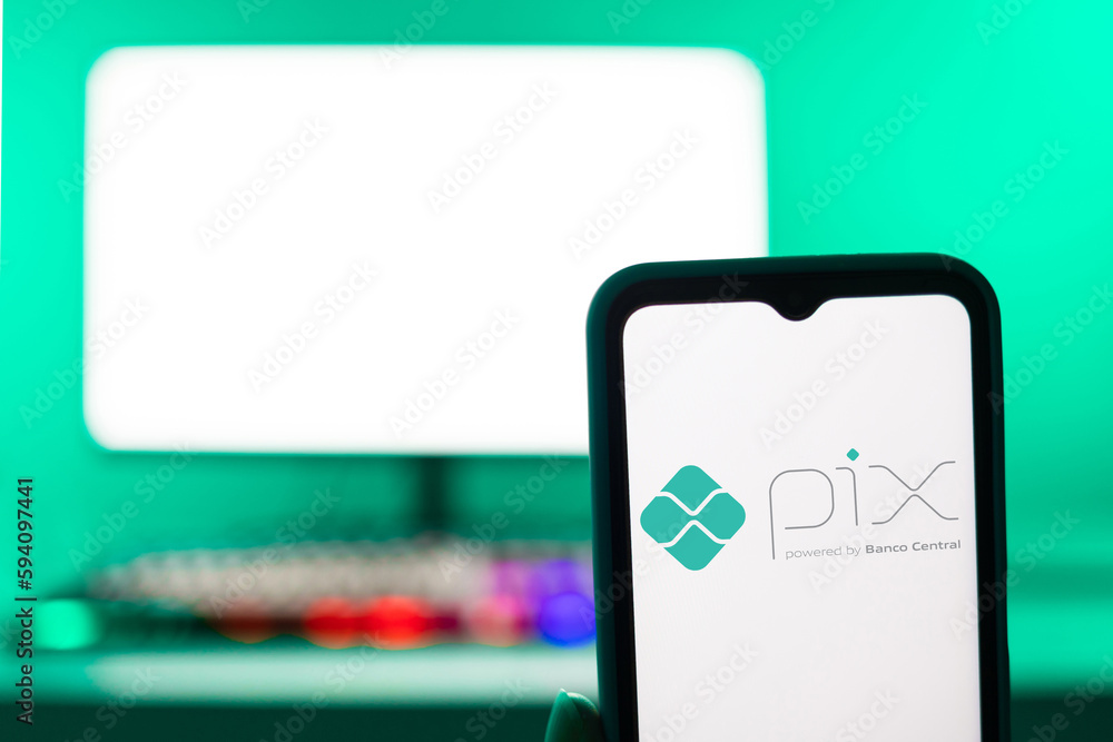 Hand holding a smartphone with a screen displaying the PIX payment ...