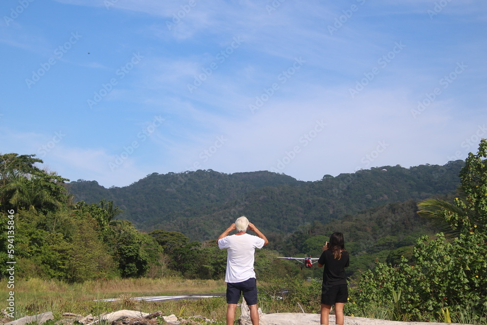 People watching a small airplane taking off from landing strip Stock ...