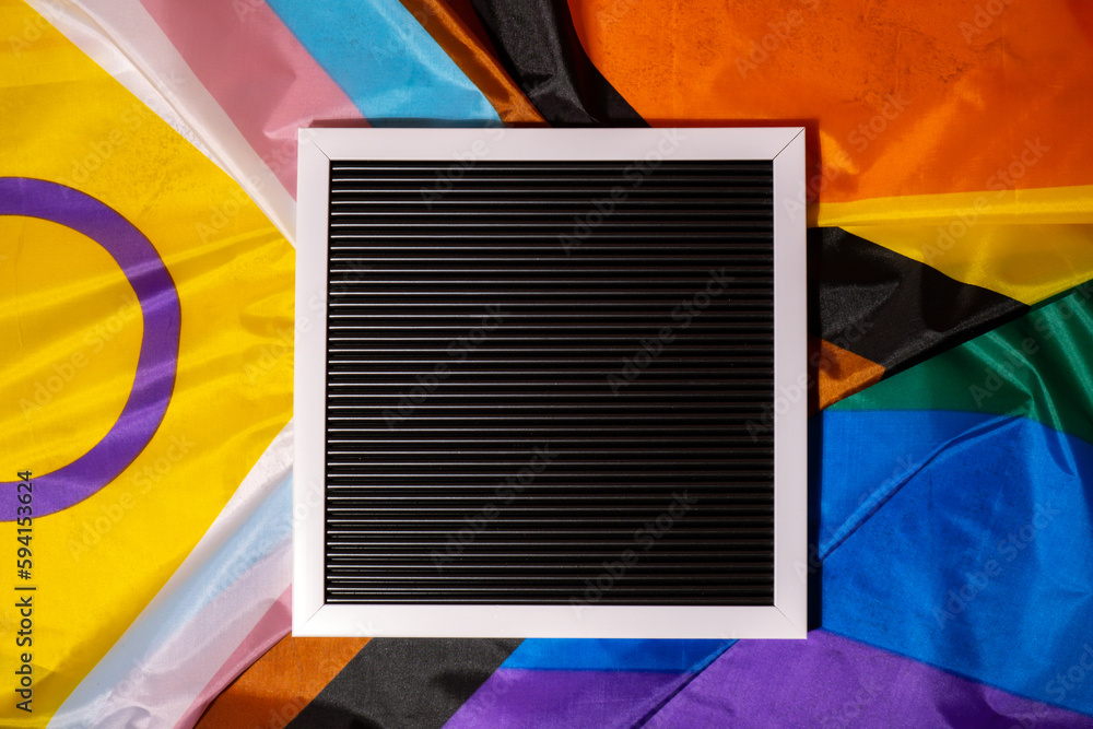 Empty blank frame on Rainbow LGBTQIA flag made from silk material with ...