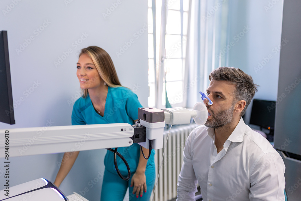 Man Performing Pulmonary Function Test And Spirometry Using Spirometer