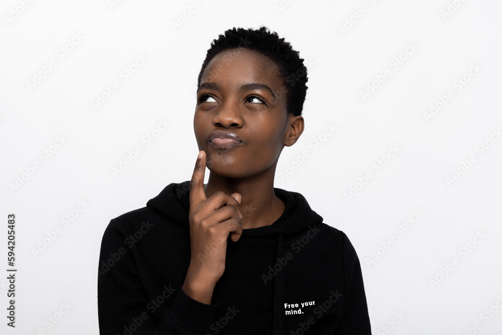 Curious dark skinned african american girl thinking about something ...