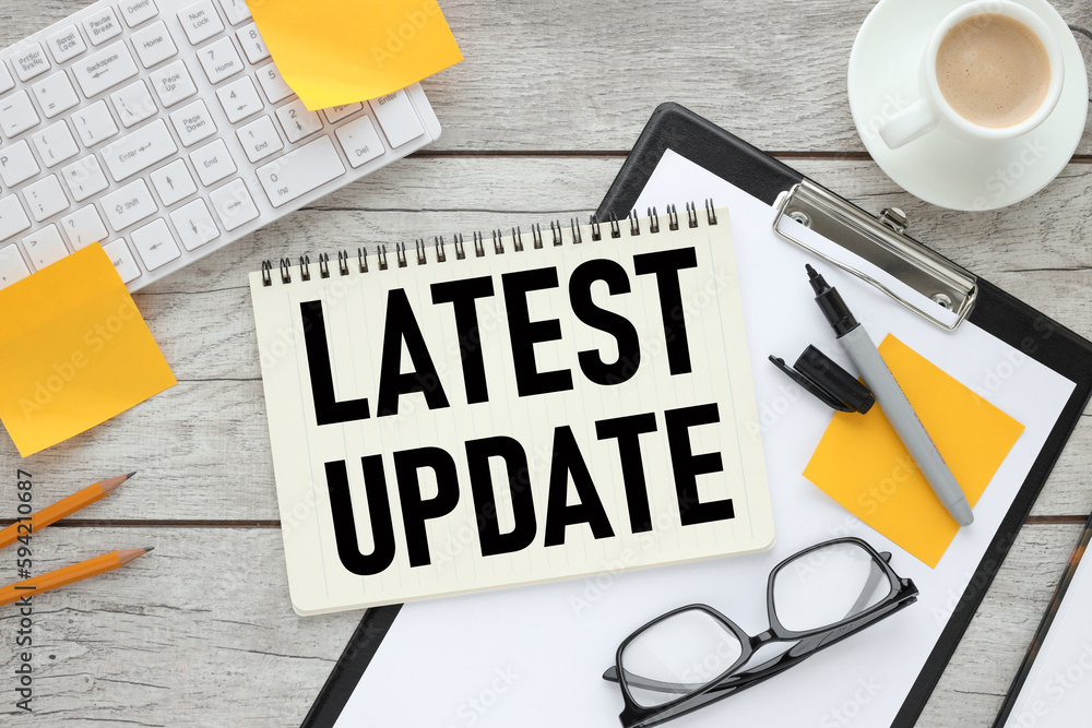 Flat lay, top view office table desk. Workspace with LATEST UPDATE text ...