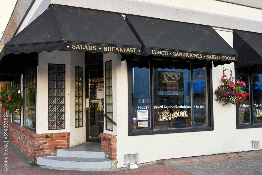 Corner entrance to a cafe that serves breakfast and lunch. Old English ...