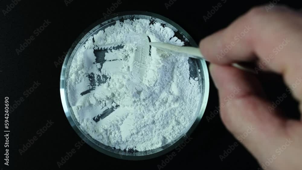 Titanium dioxide, TiO2 in Petri dish, top view. White chemical powder ...