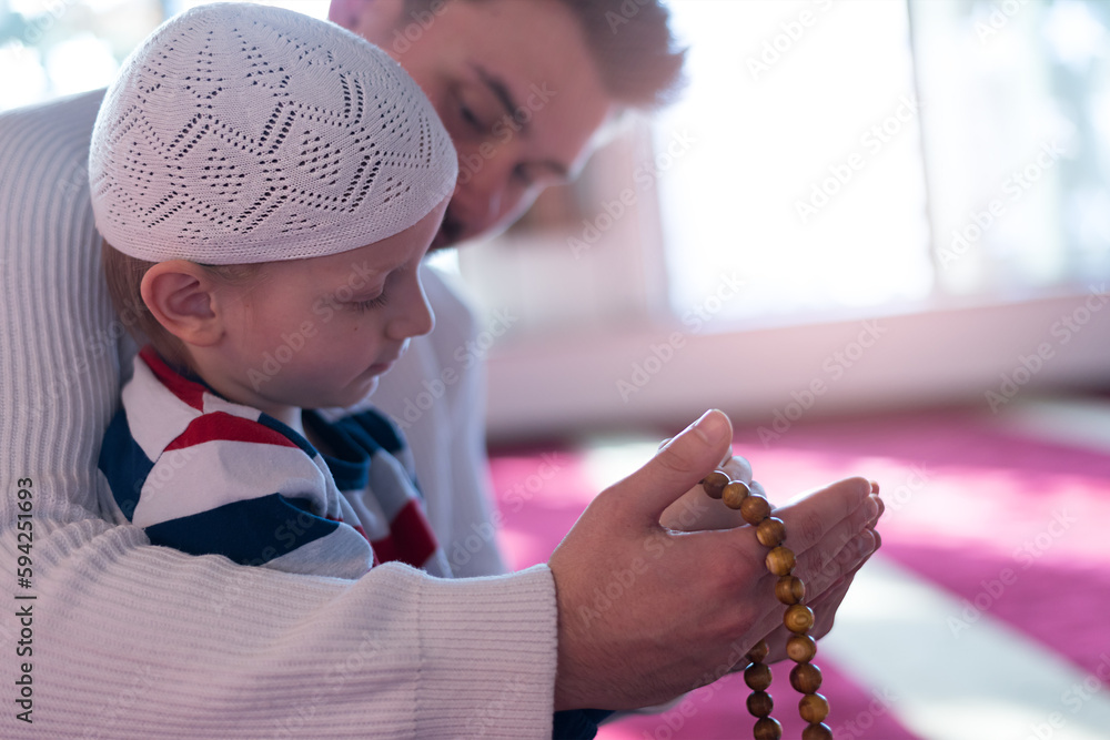 Muslim family praying. Man and childand praying. End of fasting. Hari ...