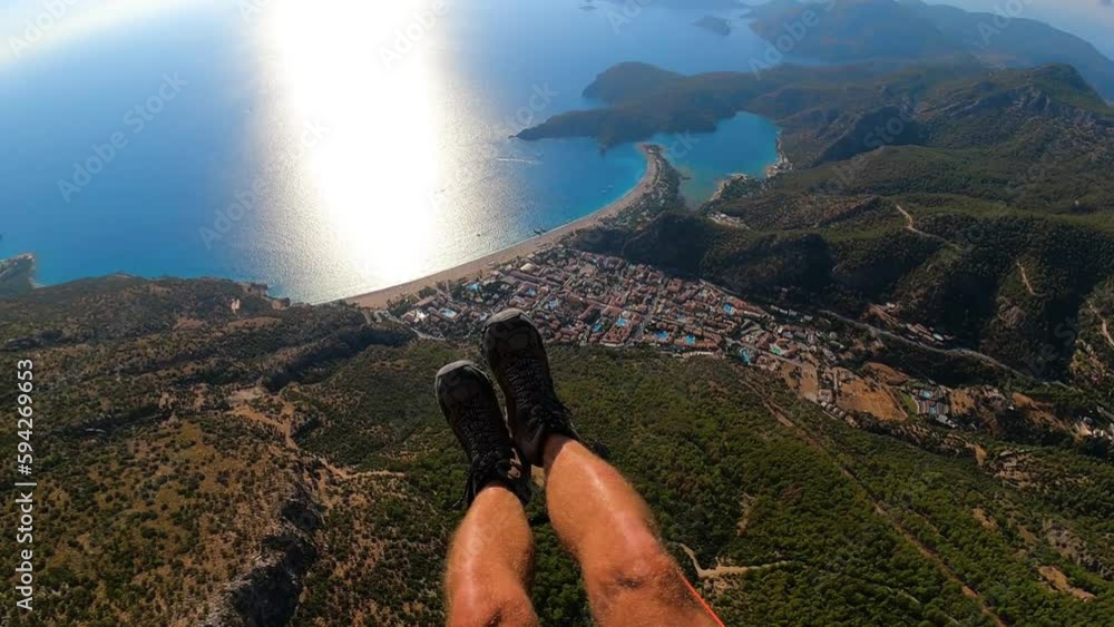 paragliding point of view flying over Oludeniz. legs paraglider over ...