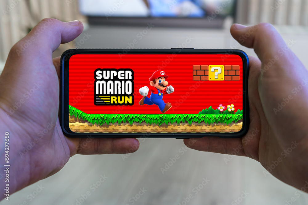 Playing Super mario run mobile game. Point of view gaming Super mario ...