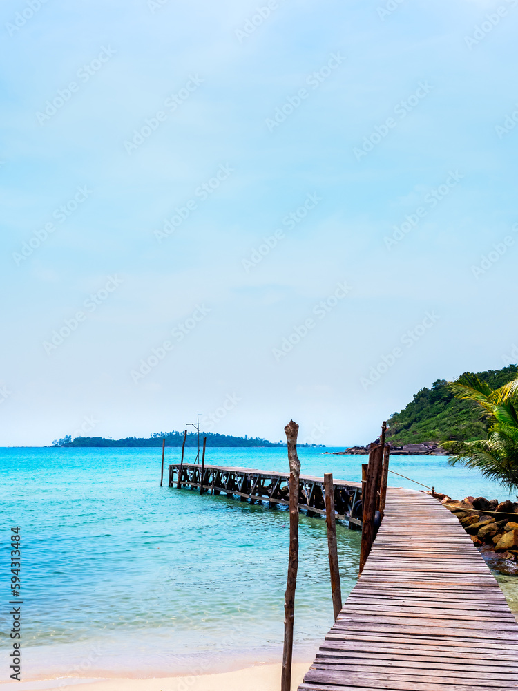 Wooden bridge heading to the blue sea. Brown wood plank pathway bridge ...