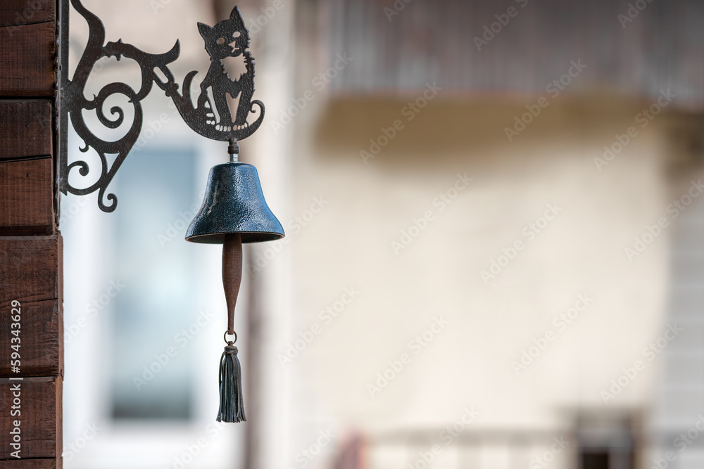 Vintage classic bronze metal door bell hanging near door entrance ...