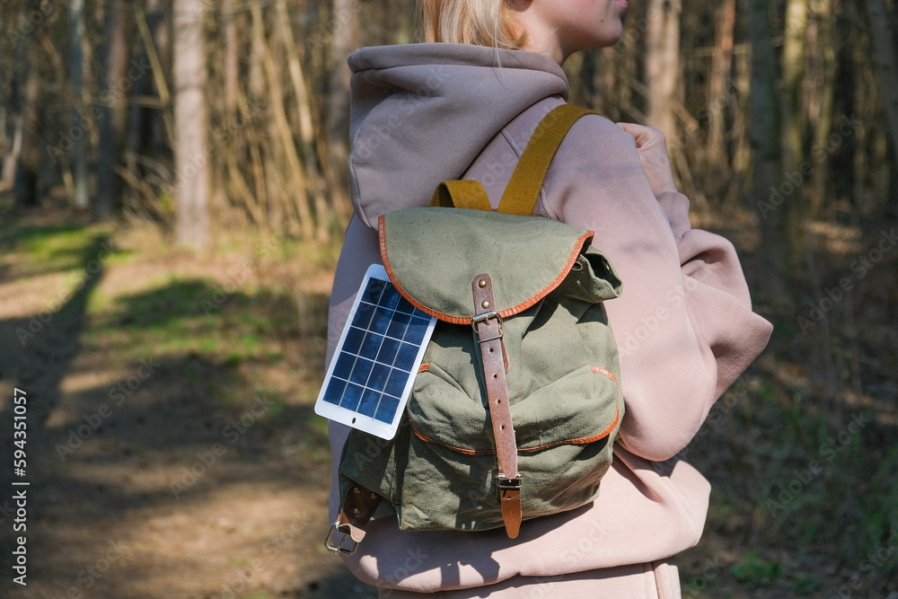 Portable solar panel.Traveler uses green energy to charge gadgets.Eco ...