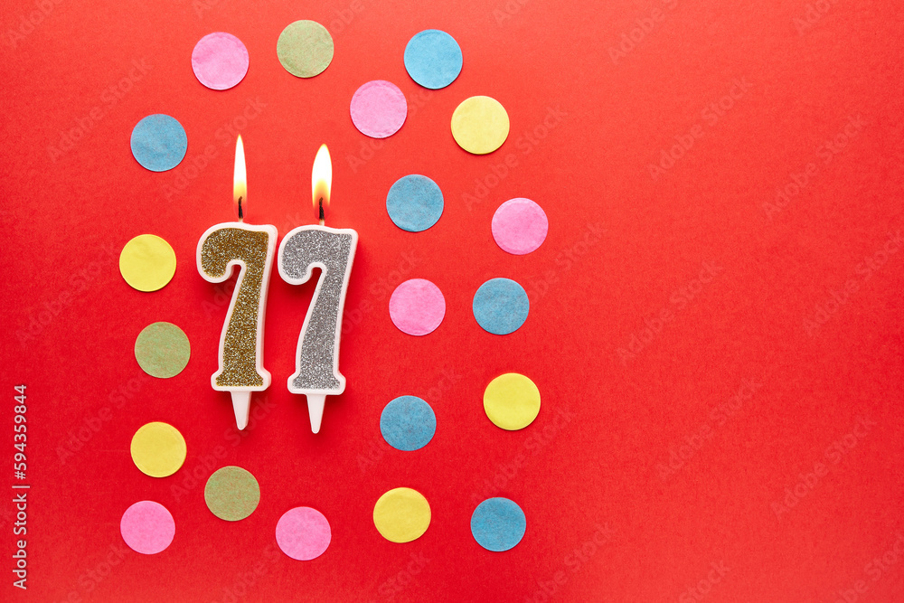 Number 77 on a red background with colored confetti. Happy birthday ...