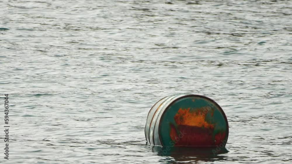Oil barrel sea. Abandoned rusty oil barrel floating in the sea ocean ...
