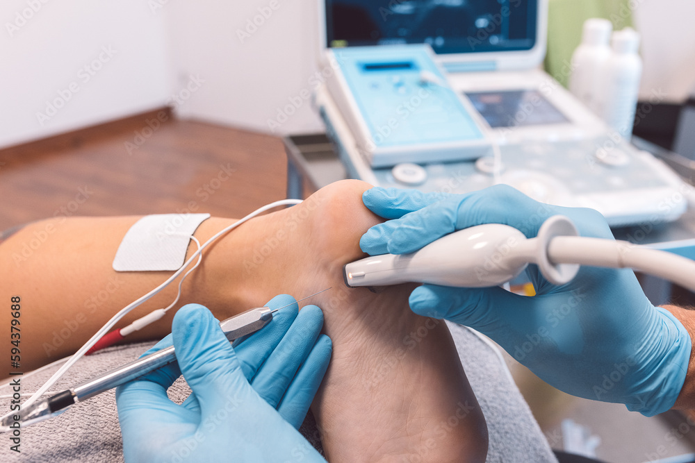 Crop doctor treating patient with ultrasound Stock Photo | Adobe Stock