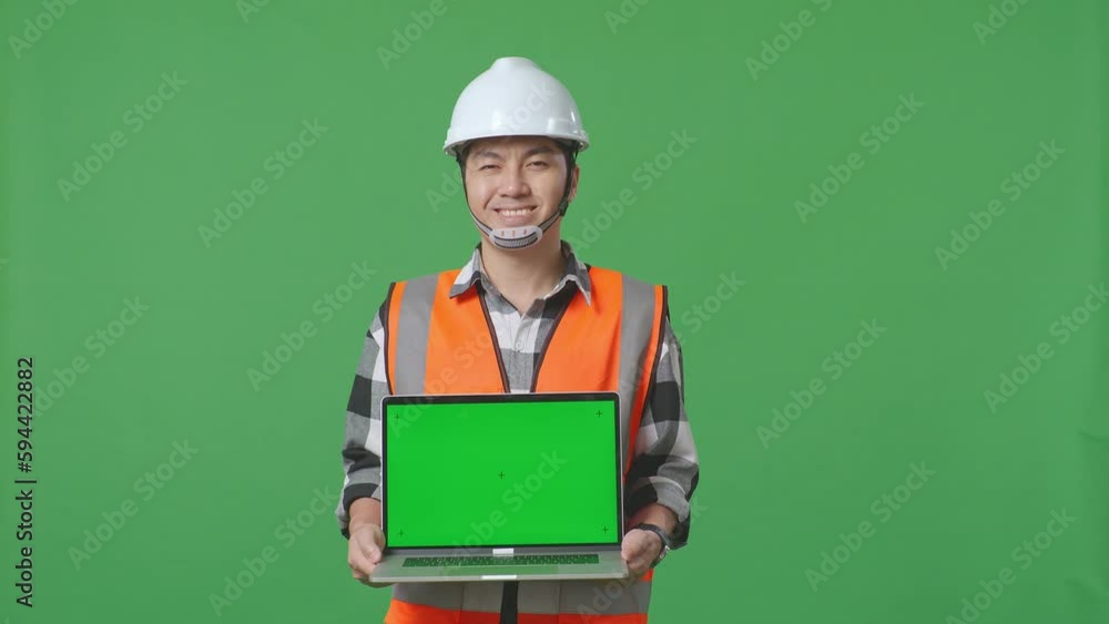 Asian Male Engineer With Safety Helmet Smiling And Showing Green Screen ...