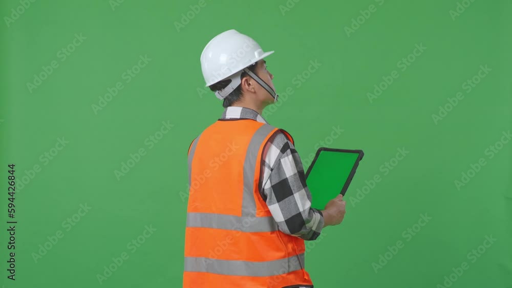 Back View Of Asian Male Engineer With Safety Helmet Working On A Green ...