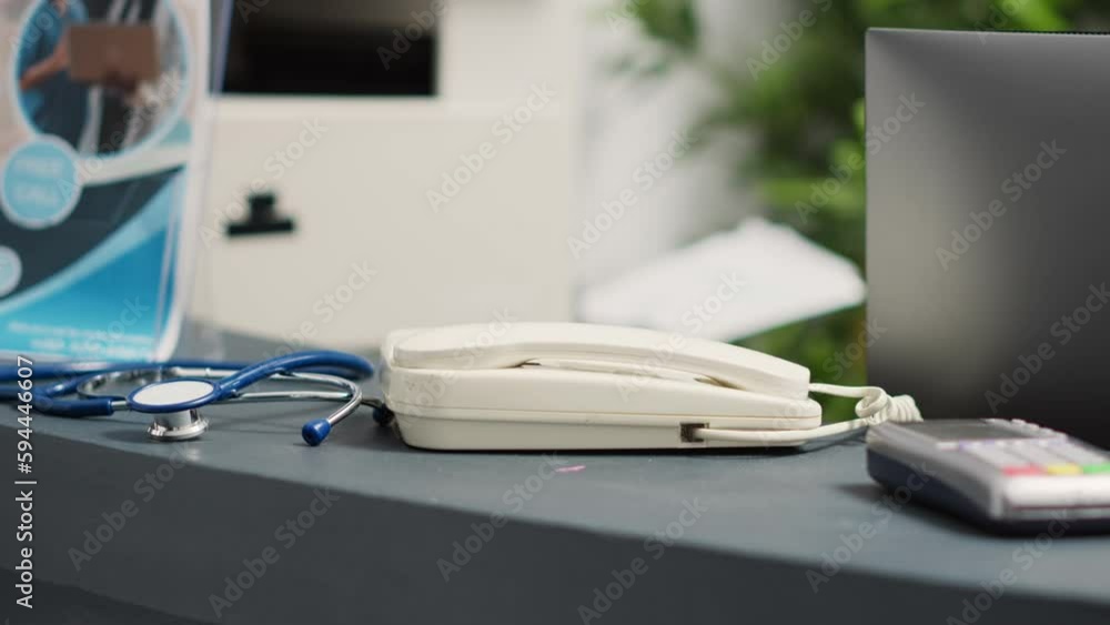 Facility counter with landline phone used to register checkup visit ...