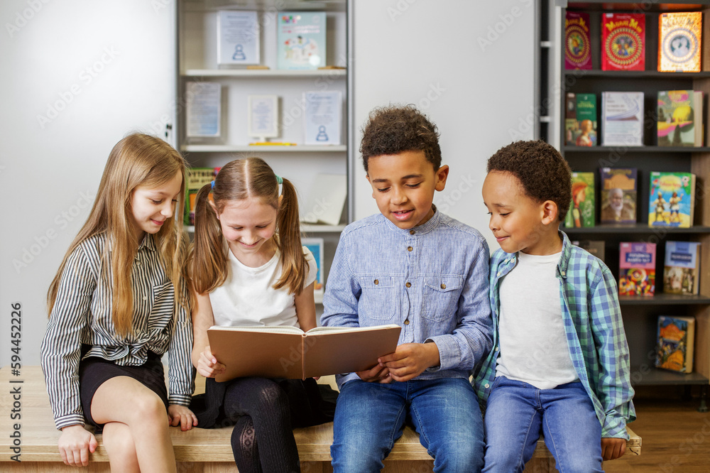 Group happy children reading book in classroom. Back to school. Study ...