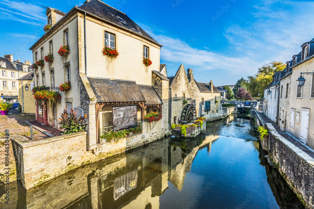Colorful old buildings, Aure River reflection, Bayeux, Normandy, France ...