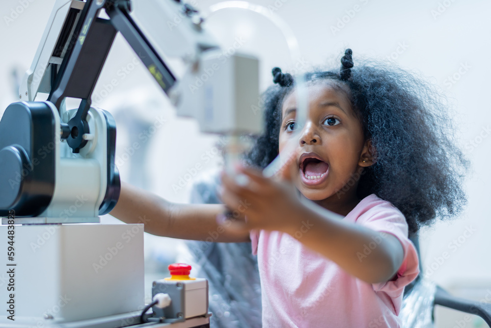 Kid female teen child enjoy Machine Learning Robot arm is Moving Under ...