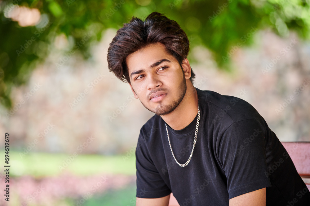 Attractive indian man smoker exhales cigarette smoke portrait in black ...