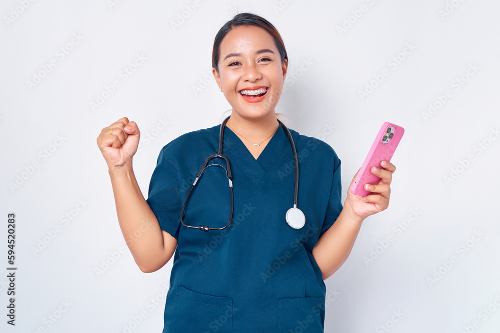 Excited young Asian woman nurse working wearing a blue uniform holding ...