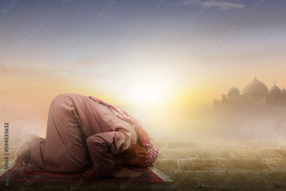 Muslim man with a beard wearing keffiyeh with agal in praying position ...