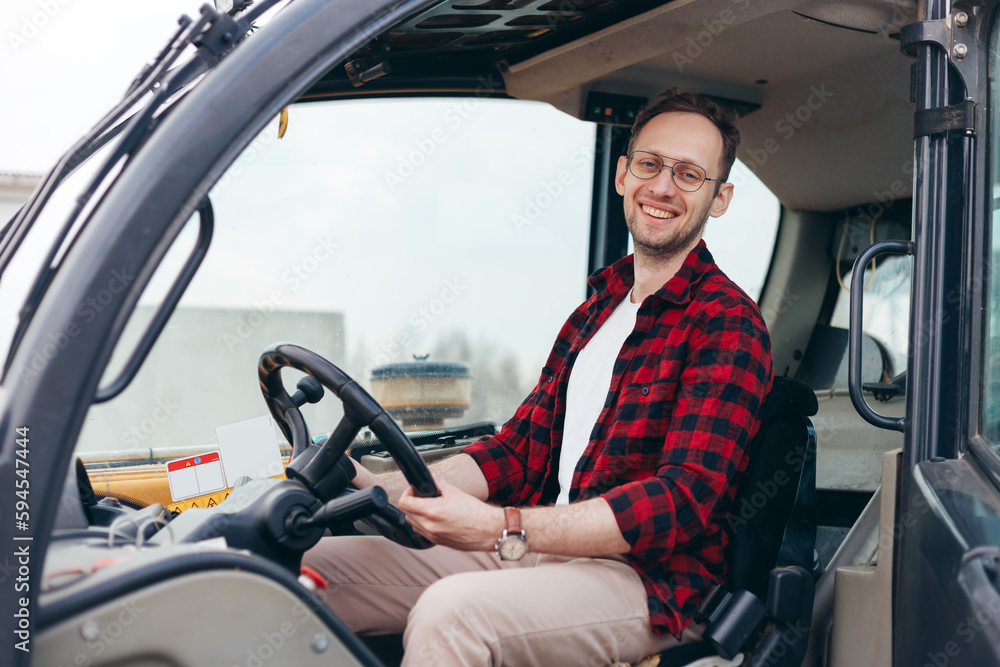 Young Rural Tractor or Combine driver sitting in the cab. Farming and ...