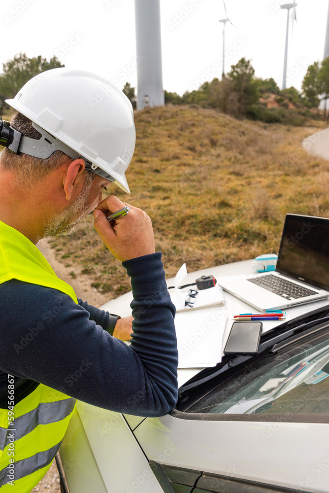 electrical engineer thinking and blueprint of wind turbine for ...