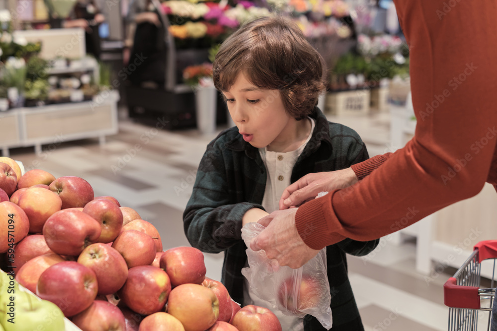 father and his son working together to select the freshest and tastiest ...
