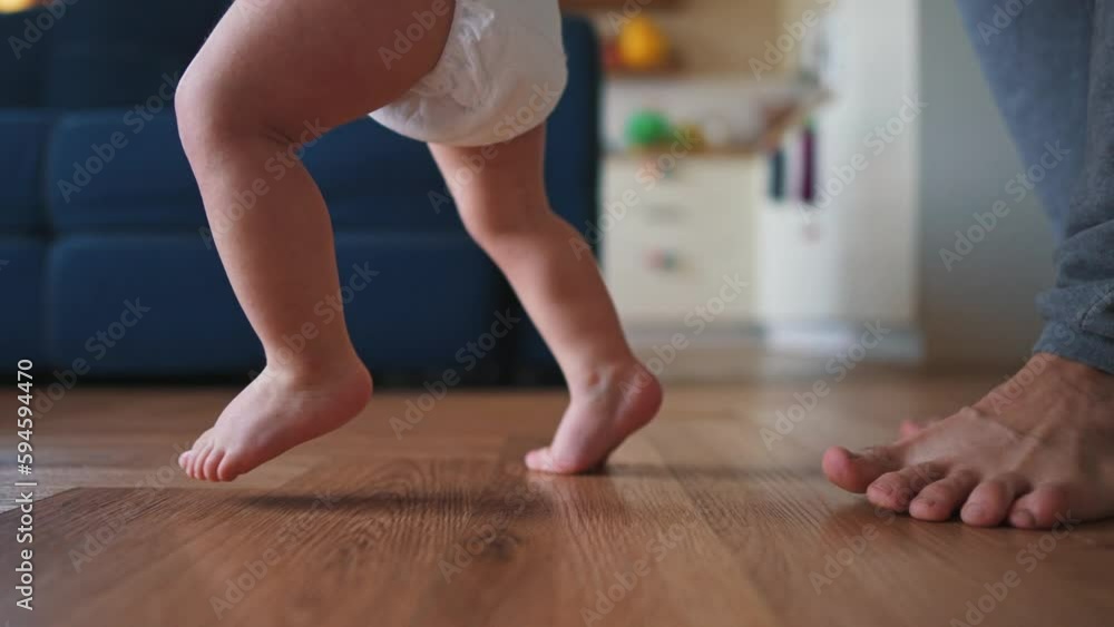 baby takes first steps. happy family a first steps kid dream concept ...