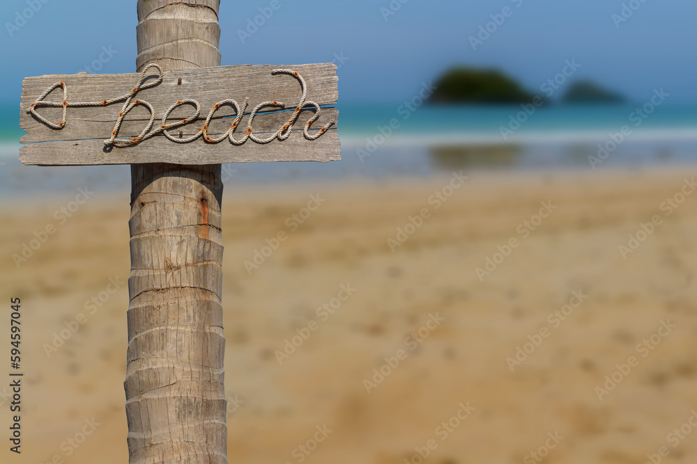 Beach sign made from manila rope on old wooden board and coconut pole ...