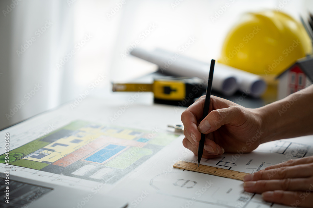 Engineer, architect, contractor starting to draw house plan structural blueprint on workbench ...