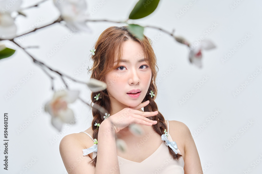 Beautiful Young Asian woman behind flower in beauty pose. Pretty girl ...